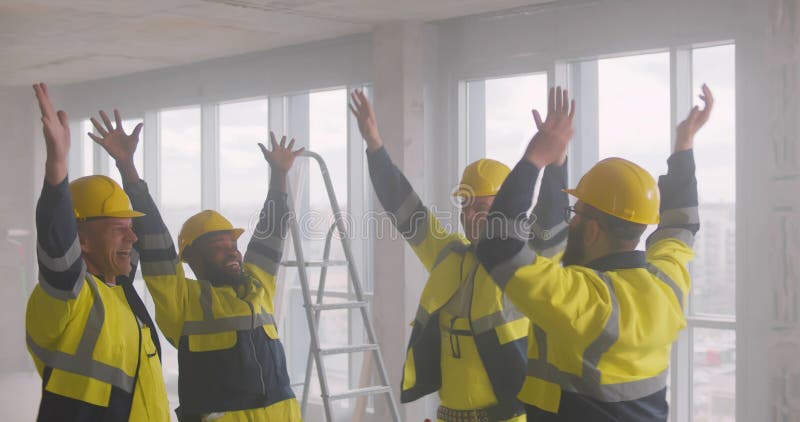 Diverse Team of Construction Workers Join Hands To Build Successful ...