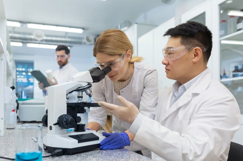 A Diverse Team of Doctors and Scientists Works in the Laboratory. Asian ...
