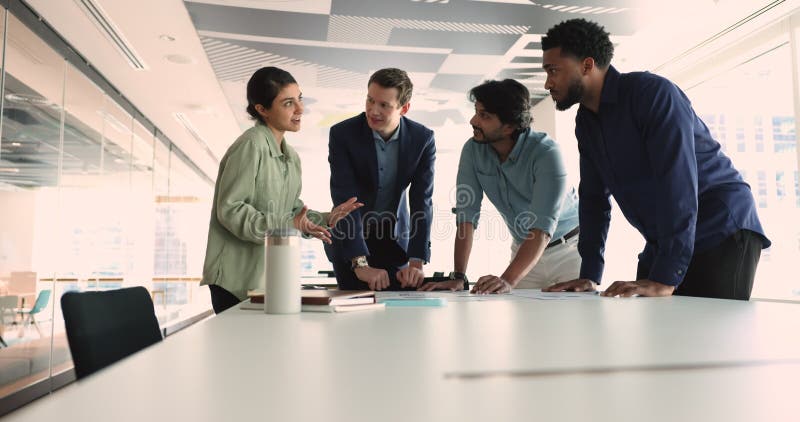 Diverse Team of Executives Discussing Business Process Map at Table ...