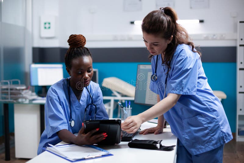 Nurse Checking Appointments on Tablet Stock Photo - Image of clinic ...
