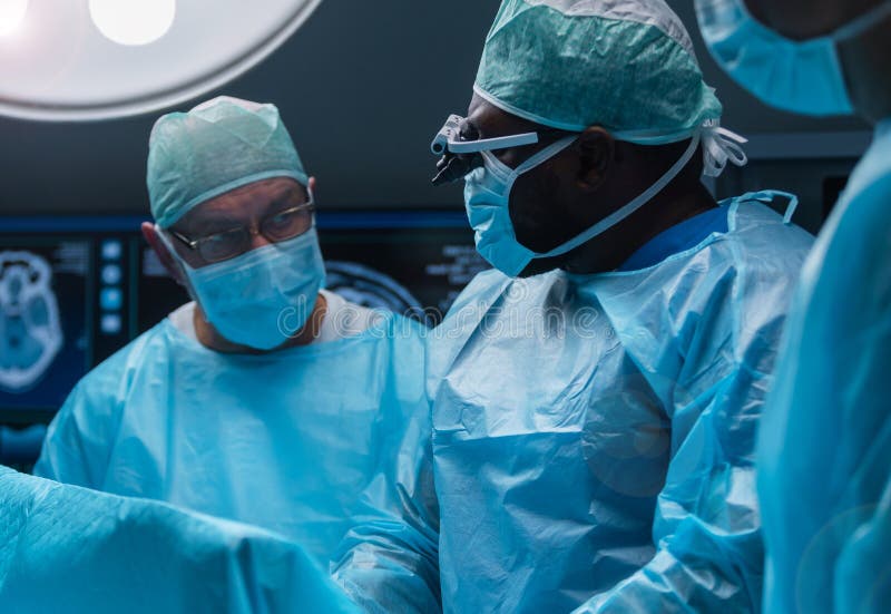 Team of Medical Doctors Performs Surgical Operation in Modern Operating ...