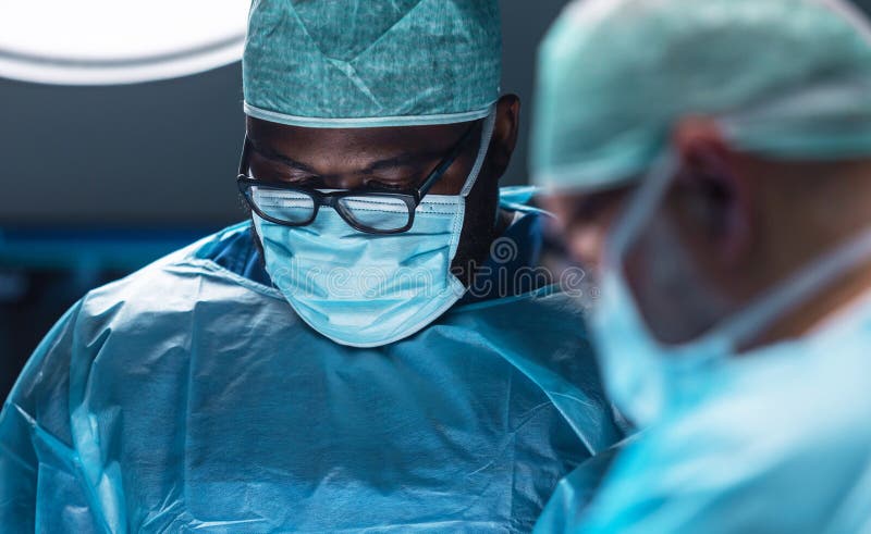 Team of Medical Doctors Performs Surgical Operation in Modern Operating ...