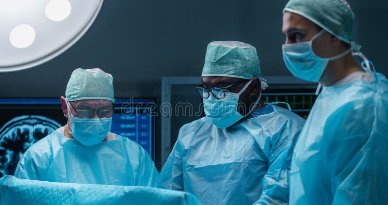 Team of Medical Doctors Performs Surgical Operation in Modern Operating ...