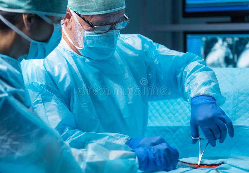 Team of Medical Doctors Performs Surgical Operation in Modern Operating ...