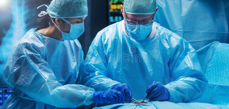 Diverse Team of Professional Medical Surgeons Perform Surgery in the ...