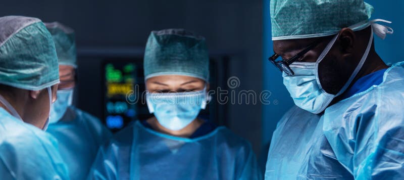 Diverse Team of Professional Medical Surgeons Perform Surgery in the ...
