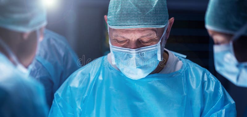 Diverse Team of Professional Medical Surgeons Perform Surgery in the ...