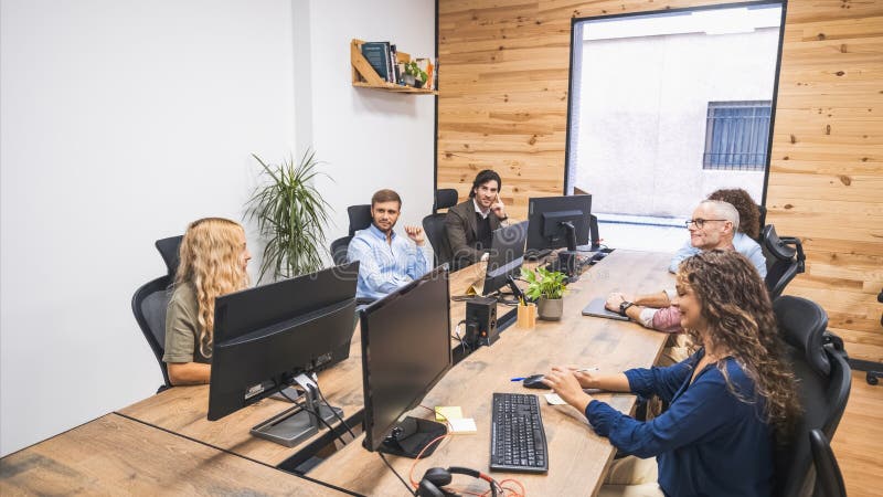 Team of Six People Having a Meeting in a Modern Office, Seated Around ...