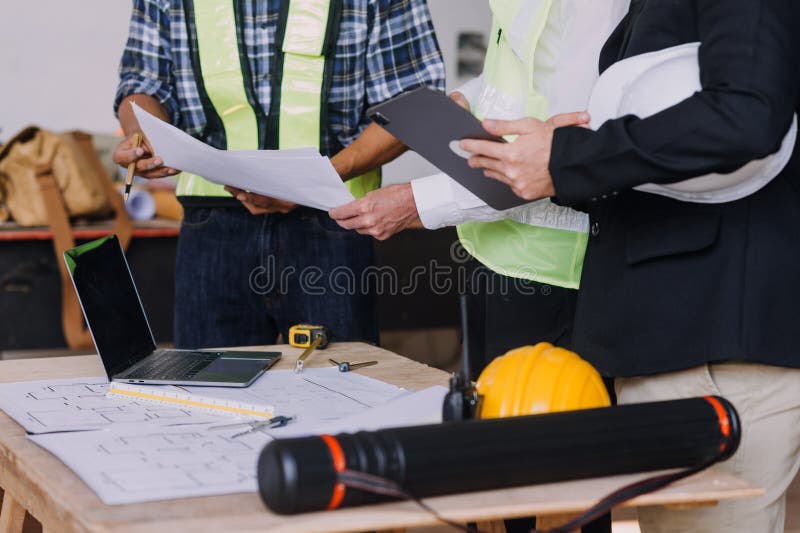 Diverse Team of Specialists Use Tablet Computer on Construction Site ...