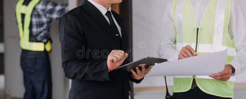 Diverse Team of Specialists Use Tablet Computer on Construction Site ...