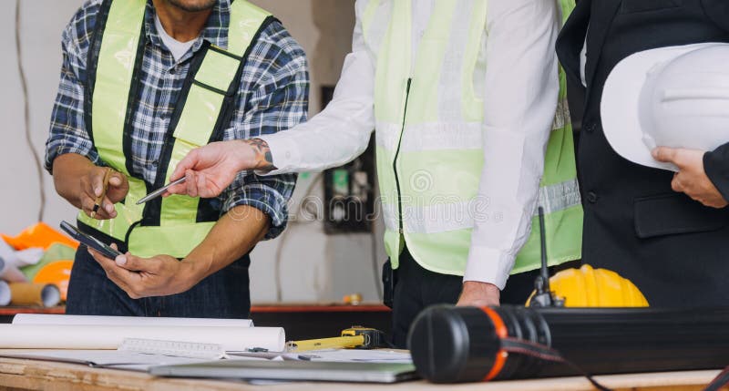 Diverse Team of Specialists Use Tablet Computer on Construction Site ...