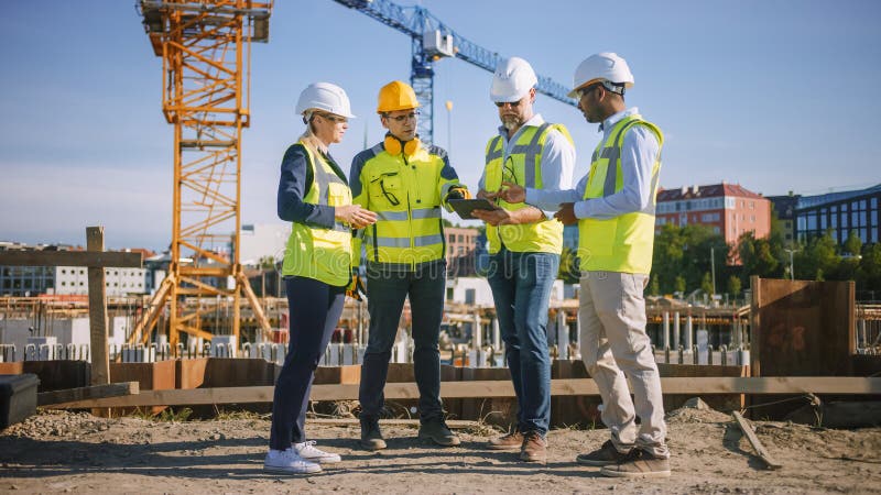 Diverse Team of Specialists Use Tablet Computer on Construction Site ...