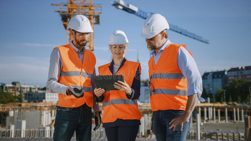 Diverse Team of Specialists Use Tablet Computer on Construction Site ...