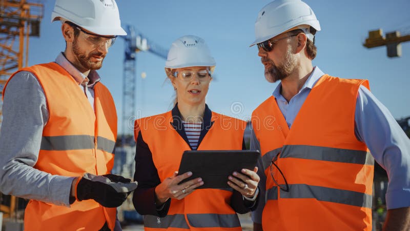 Diverse Team of Specialists Use Tablet Computer on Construction Site ...