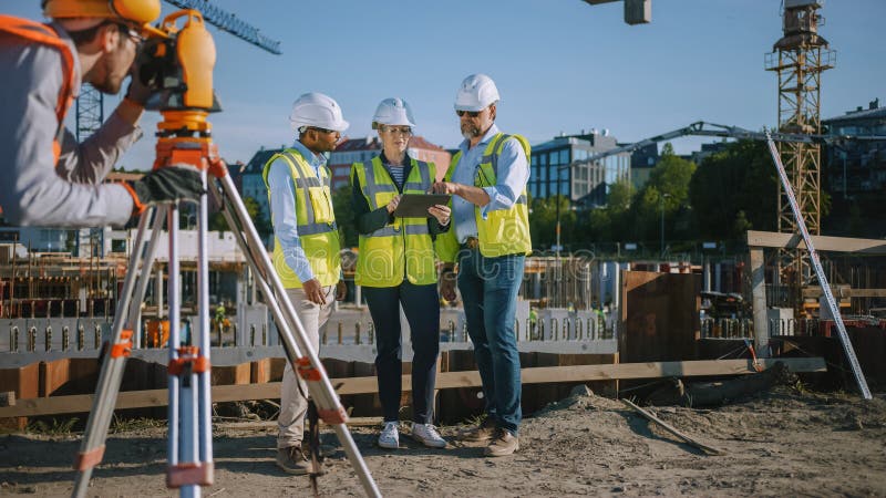 Diverse Team of Specialists Use Tablet Computer on Construction Site ...