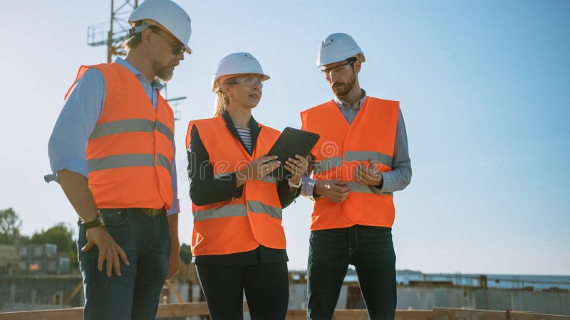Diverse Team of Specialists Use Tablet Computer on Construction Site ...