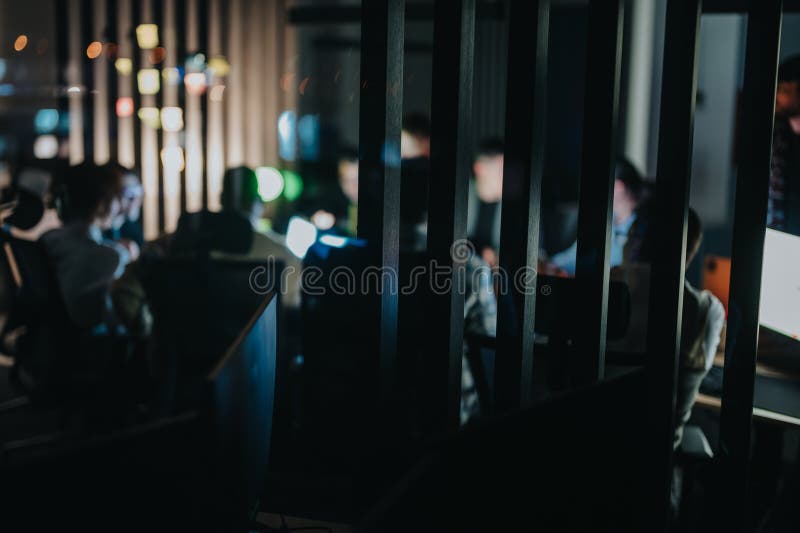 Diverse Team Working Late on a Collaborative Project in Modern Office ...