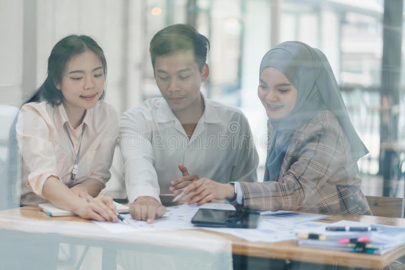 Diverse Team Working Together on Tablet in Modern Office. Stock Photo ...