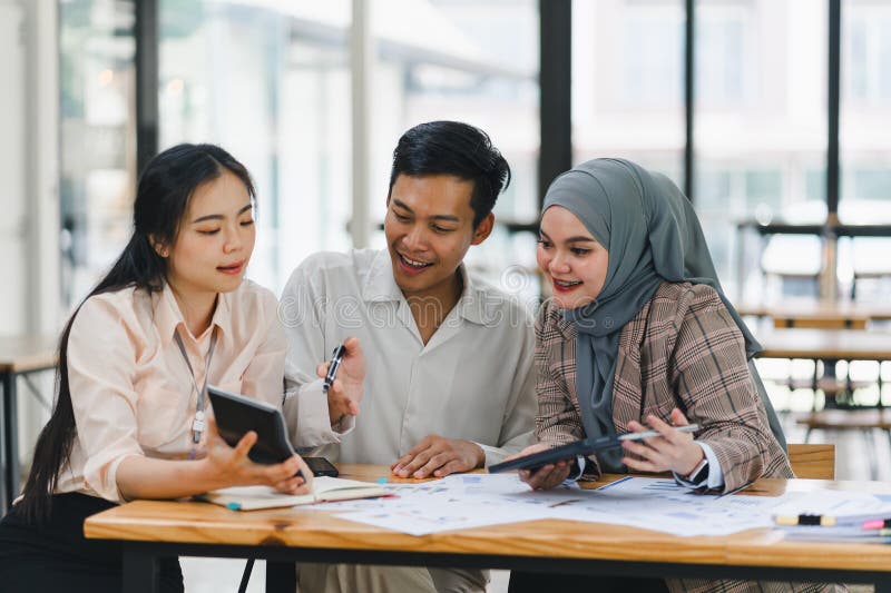 Diverse Team Working Together on Tablet in Modern Office. Stock Photo ...