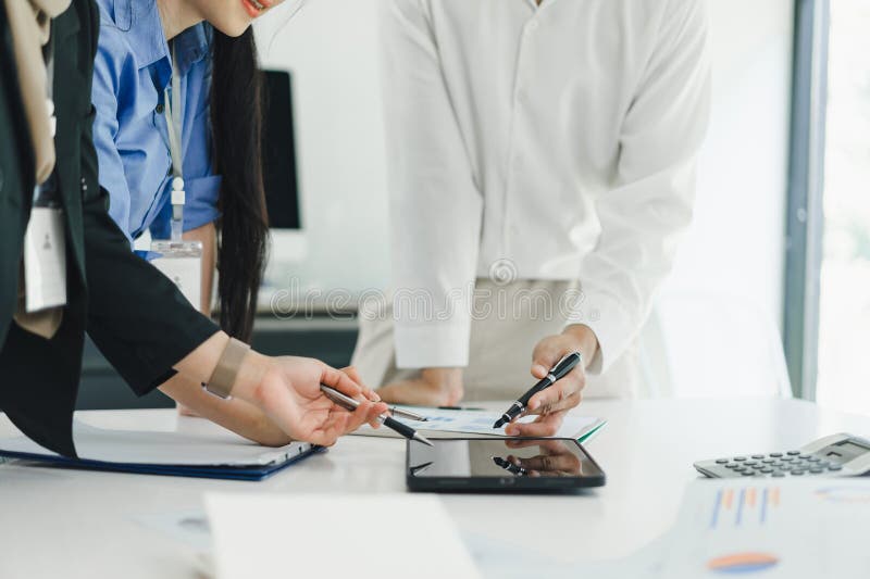 Diverse Team Working Together on Tablet in Modern Office. Stock Photo ...