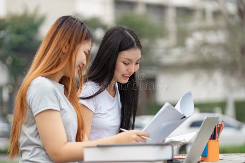Diverse University Students Focused on Studying with Documents and a ...