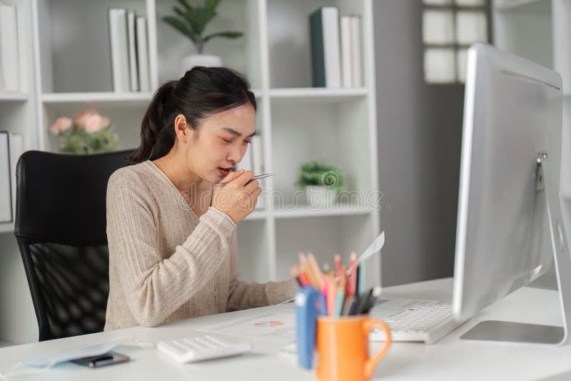 Diverse Woman Working in an Office, Focusing on Documents and Sipping a ...