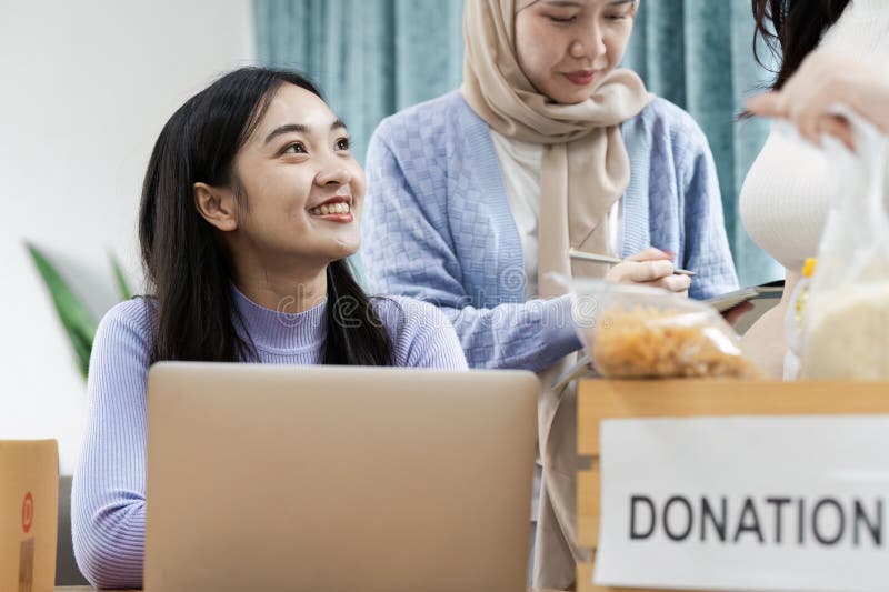Diverse Women Collaborating on Donation Project, Discussing ...