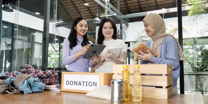 Diverse Women Smiling and Collaborating on Donation Items for Community ...