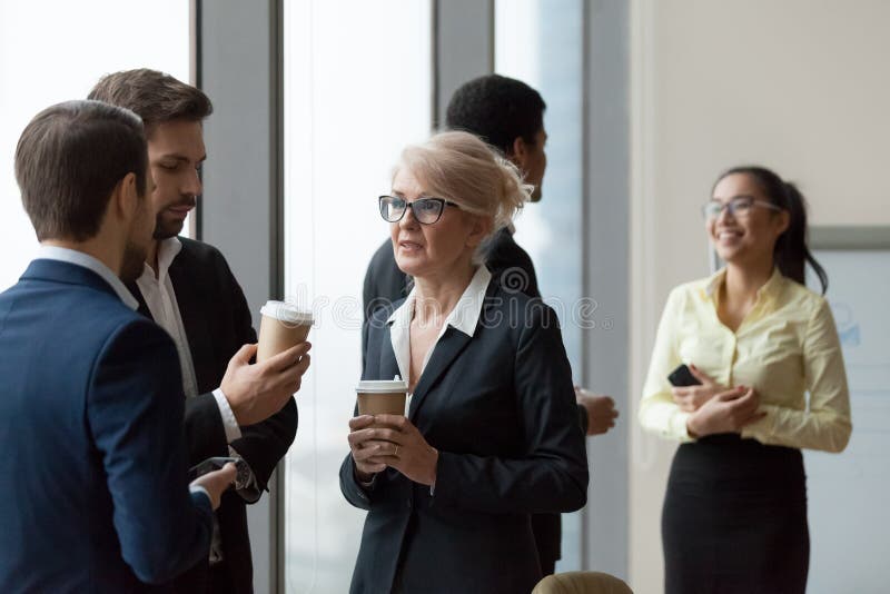 Diverse Workers Having Conversation Standing in Office at Work Break ...