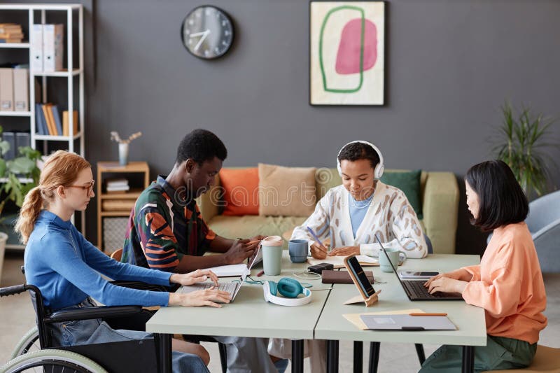 Diverse Young Team Working Together at Common Table in Office Stock ...