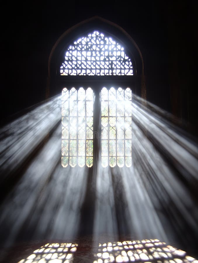 Divine Light Streaming through Ornate Gothic Arch Window in Historic ...