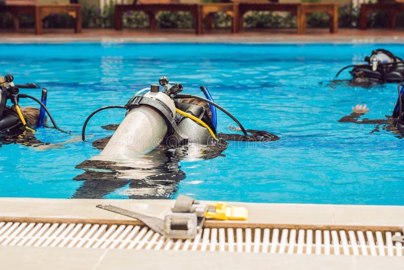 Diving Instructor and Students. Instructor Teaches Students To Dive ...