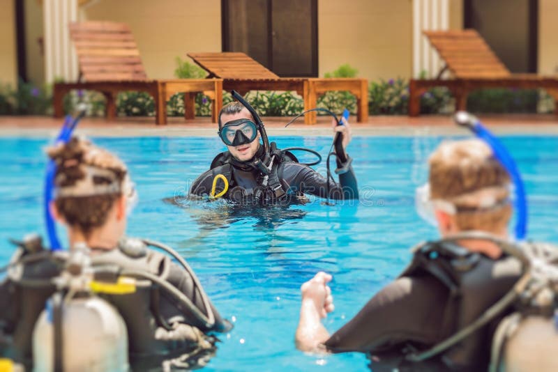 Diving Instructor and Students. Instructor Teaches Students To Dive ...