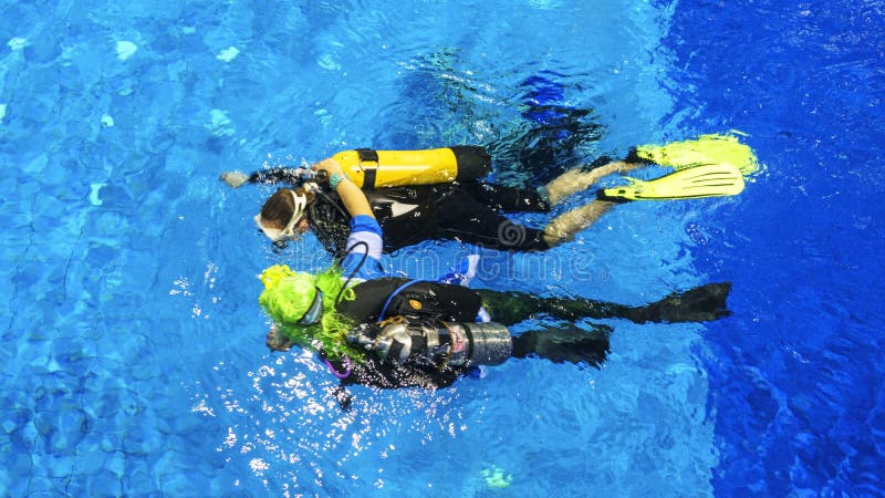 Diving Instructor and Students. Instructor Teaches Students To Dive in ...