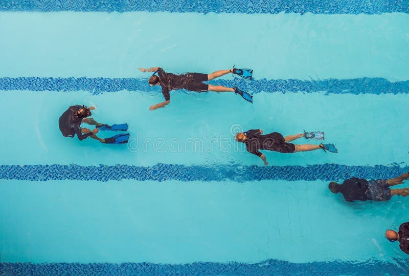 Diving Instructor and Students. Instructor Teaches Students To D ...