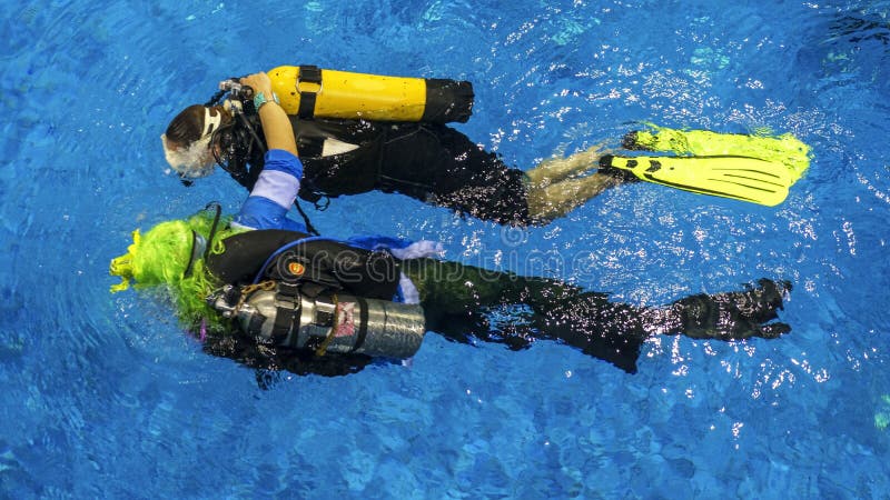 Diving Instructor and Students. Instructor Teaches Students To Dive in ...