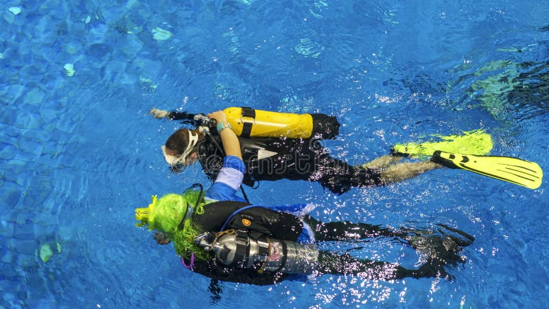 Diving Instructor and Students. Instructor Teaches Students To Dive in ...