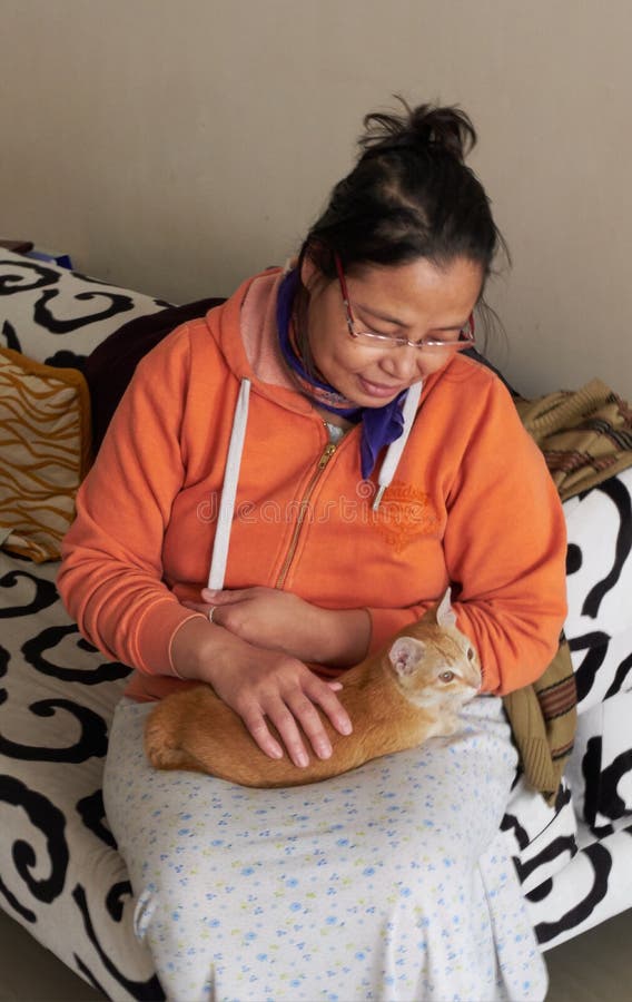 Lady with pet cat stock image. Image of kitten, touching - 176762643