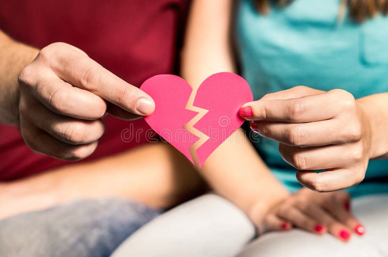 Divorce Breakup Or Separation Ripped Paper Heart In Hands Of A Couple