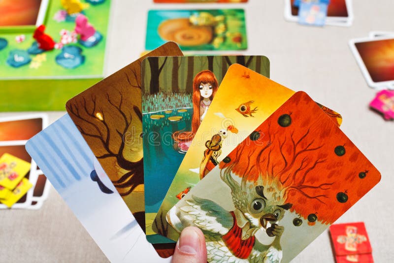 Dixit game cards in hand editorial stock image. Image of card - 37619789