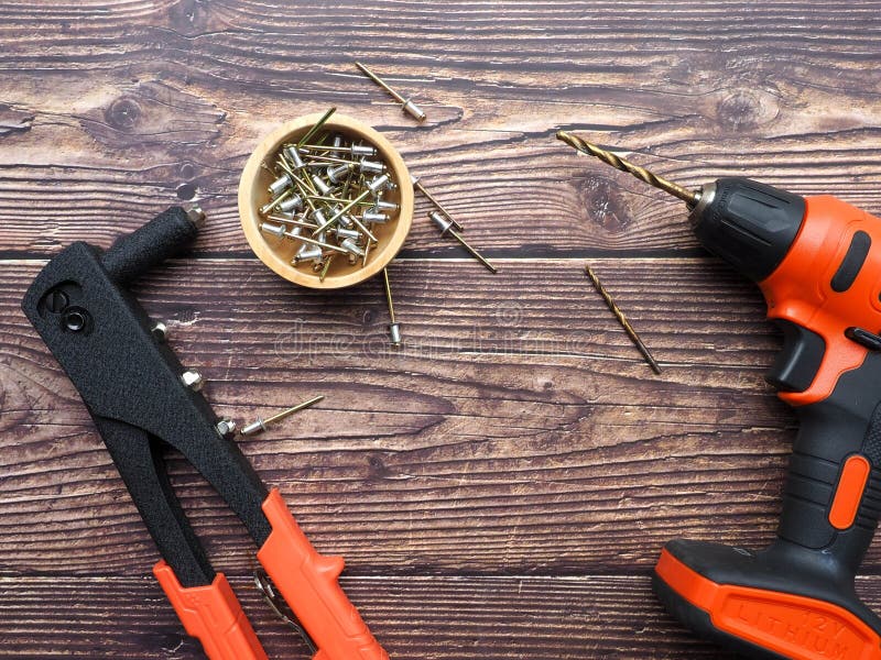 Hand Riveting Tool with Orange Handle and Cordless Drill with Blind ...