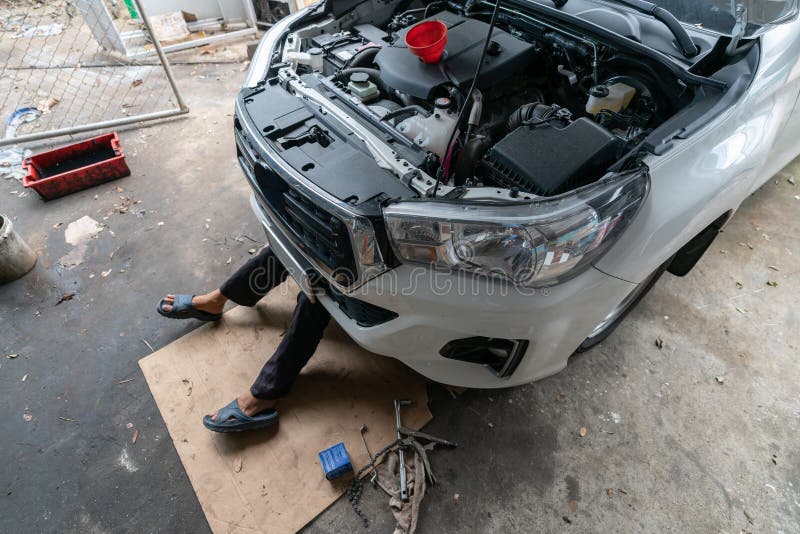 DIY Mechanic Lying and Working Under Car at Home Garage. Stock Photo ...