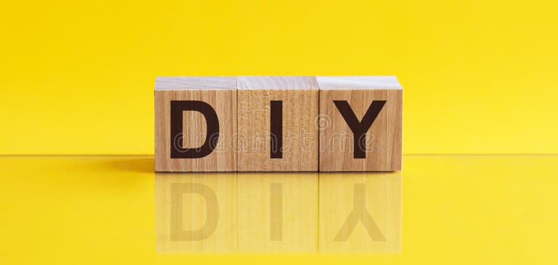 DIY the Word is Written on a Wooden Block. the Image is Mirrored in the ...