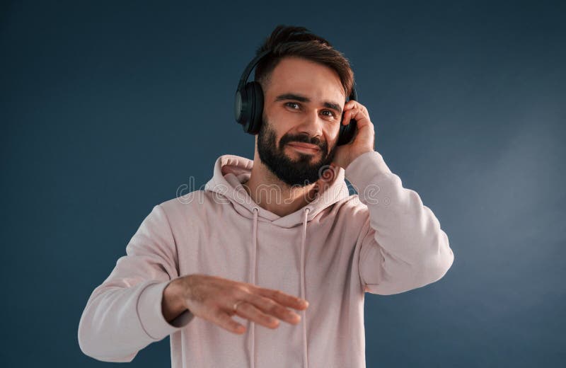 Dj in Headphones. Handsome Man is in the Studio Against Blue Background ...