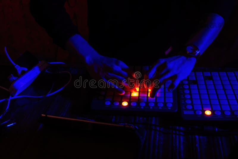 DJ Playing Synthesizer and Mixing Music in the Night Club Stock Photo ...