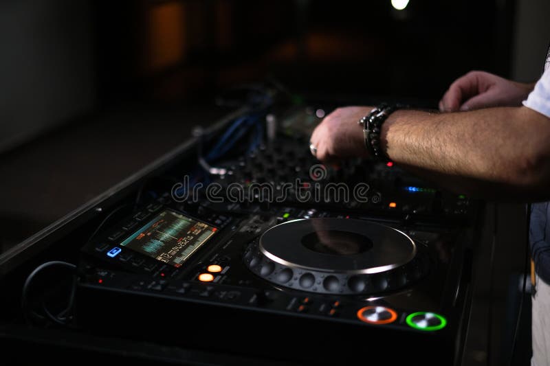 DJ Plays at the Remote Control at a Party Against the Backdrop of ...