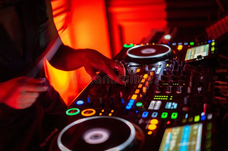 DJ Working on a Professional Controller in a Dimly Lit Room, with ...