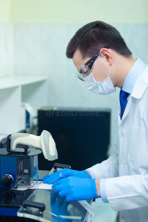 DNA Laboratory. the Expert Puts the Human DNA into the Database Using ...