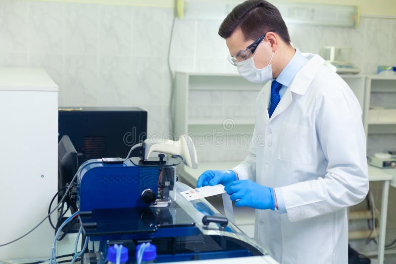 DNA Laboratory. the Expert Puts the Human DNA into the Database Using ...
