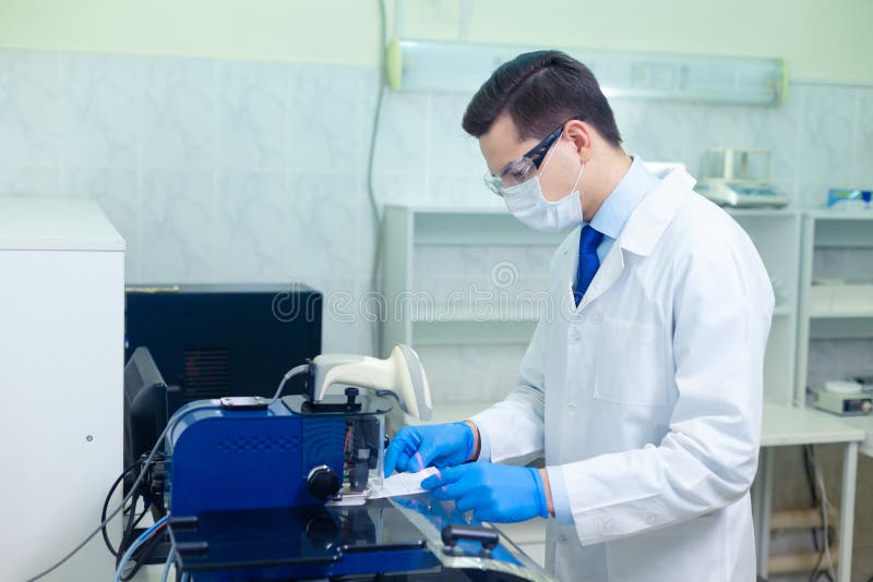 DNA Laboratory. the Expert Puts the Human DNA into the Database Using ...